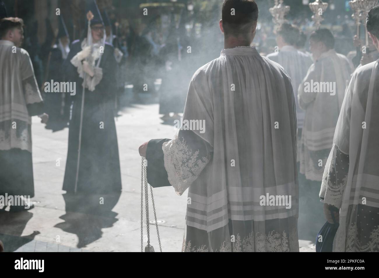 Altar boys in procession with incense and traditionally dressed on Good ...