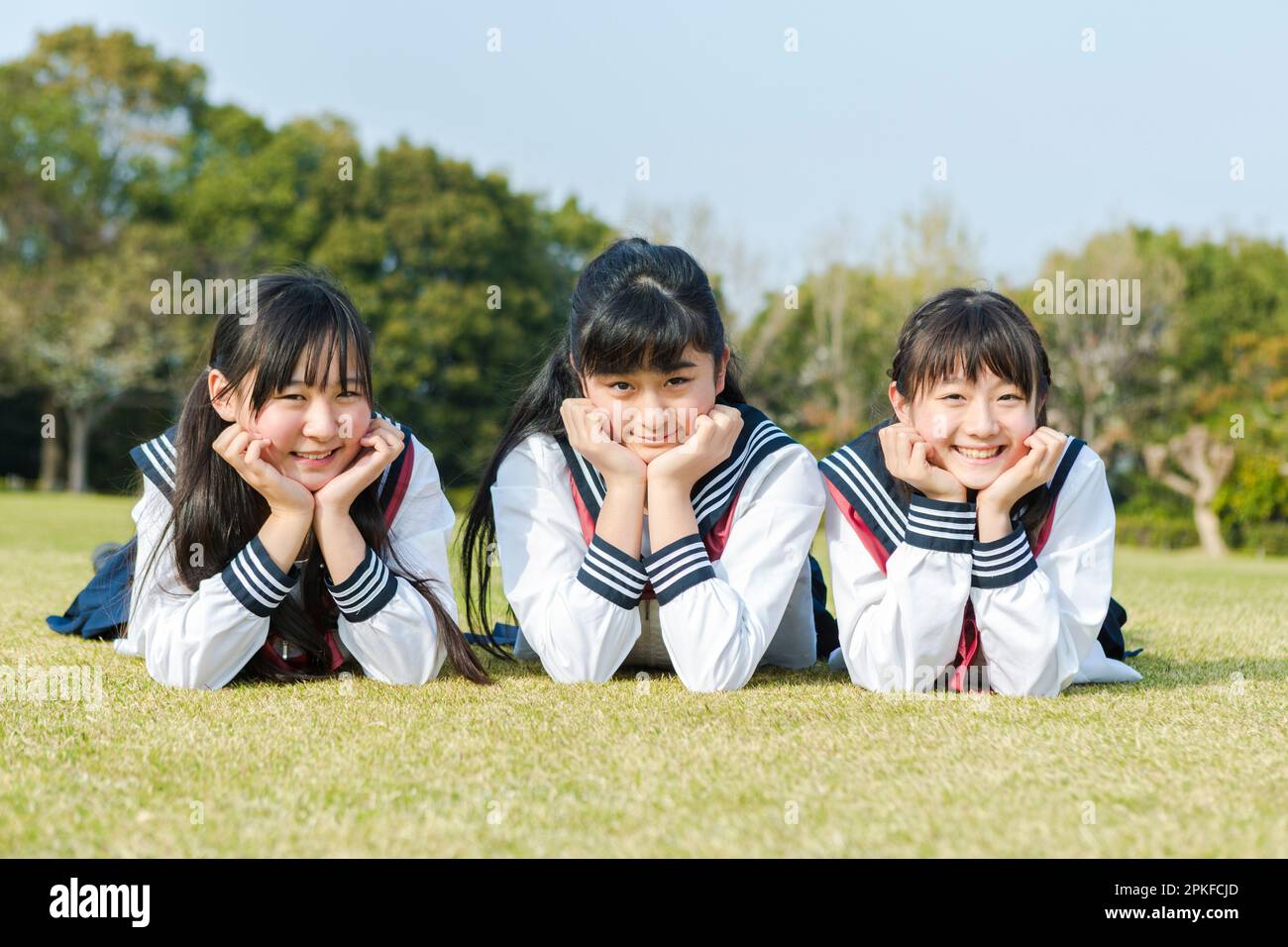 Junior high school girl lying on the lawn with cheekbones Stock Photo ...