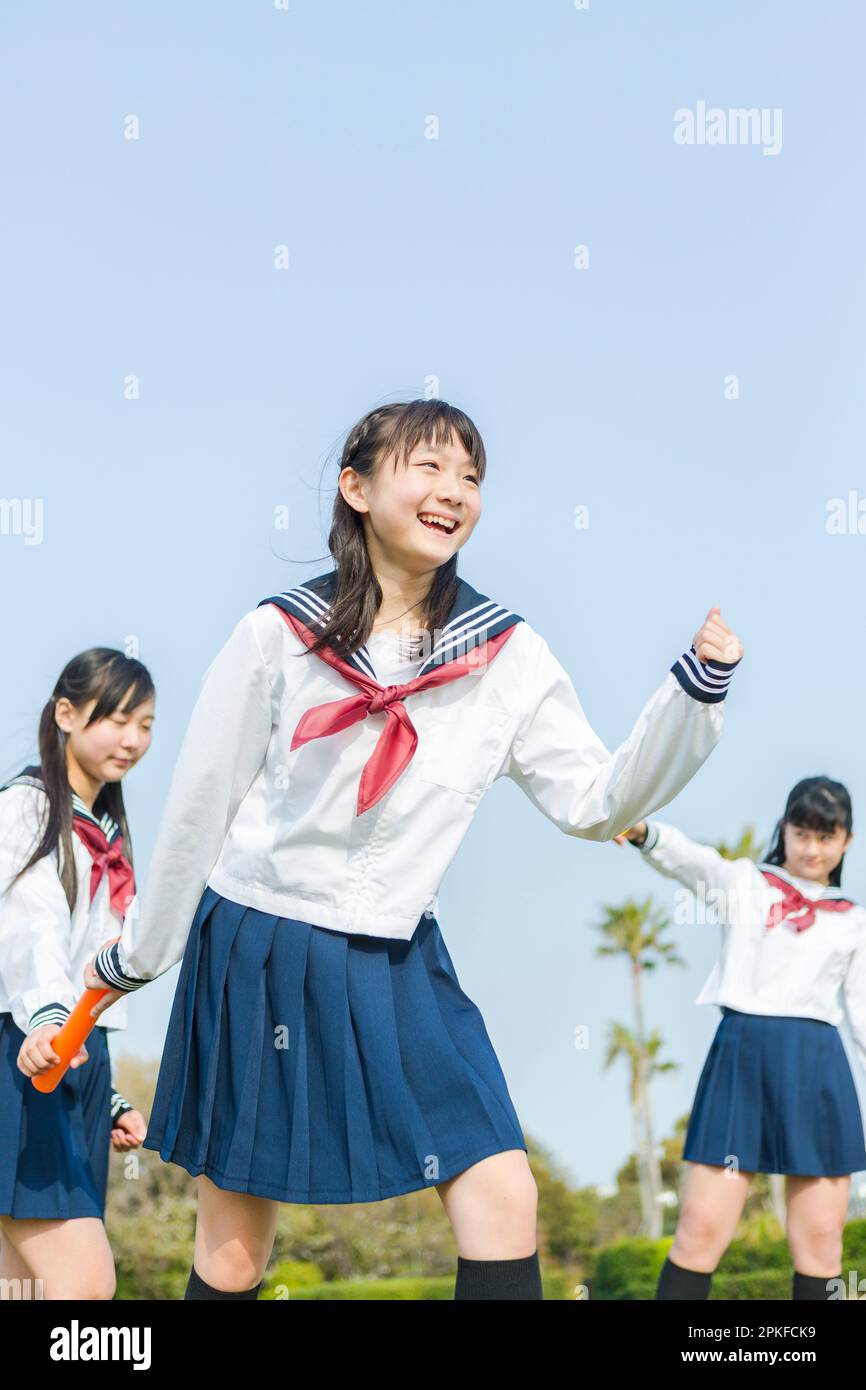 Junior high school girls receiving the baton Stock Photo - Alamy