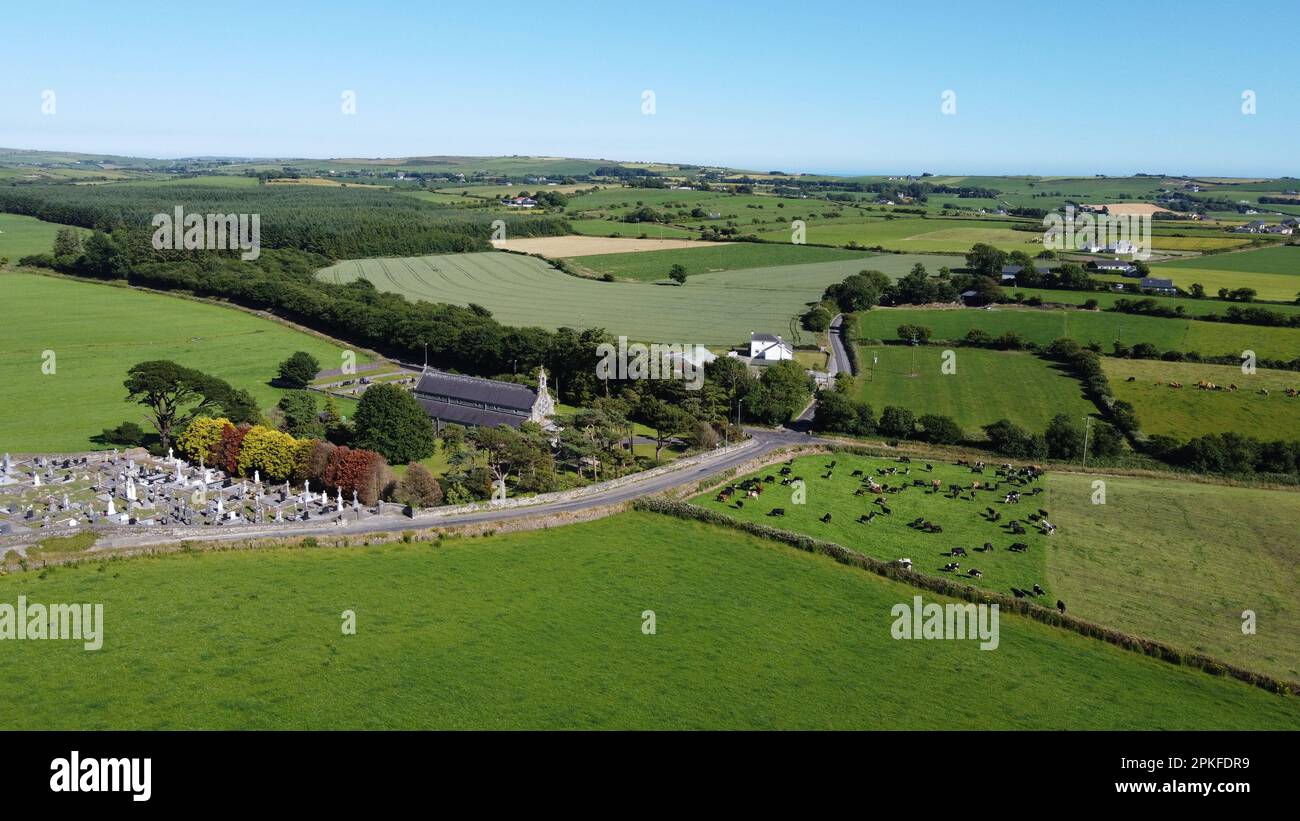 Old Catholic church and cemetery among green farm fields, top view ...