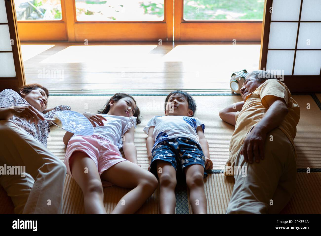 Grandparents and grandchildren taking a nap in Japanese-style room ...