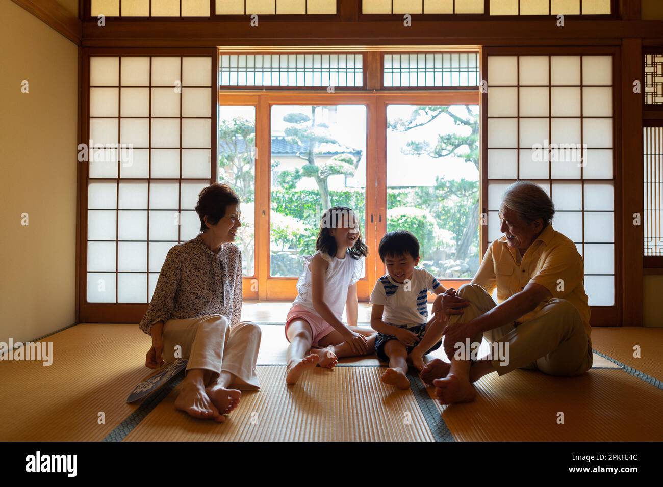 Grandparents and grandchildren enjoying a happy time in a Japanese ...