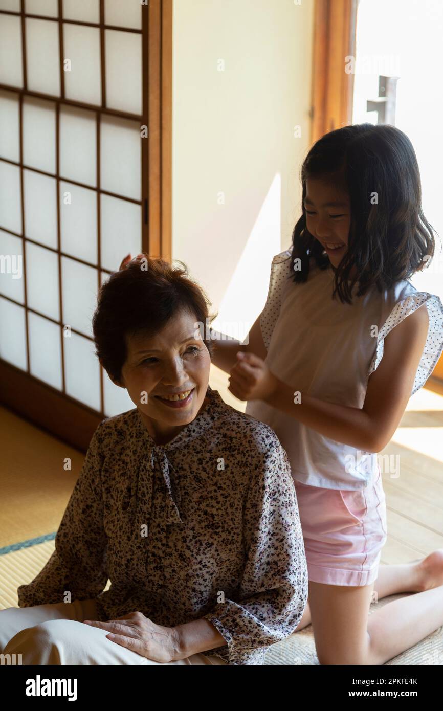 Grandson tapping his grandfather on the shoulder Stock Photo - Alamy