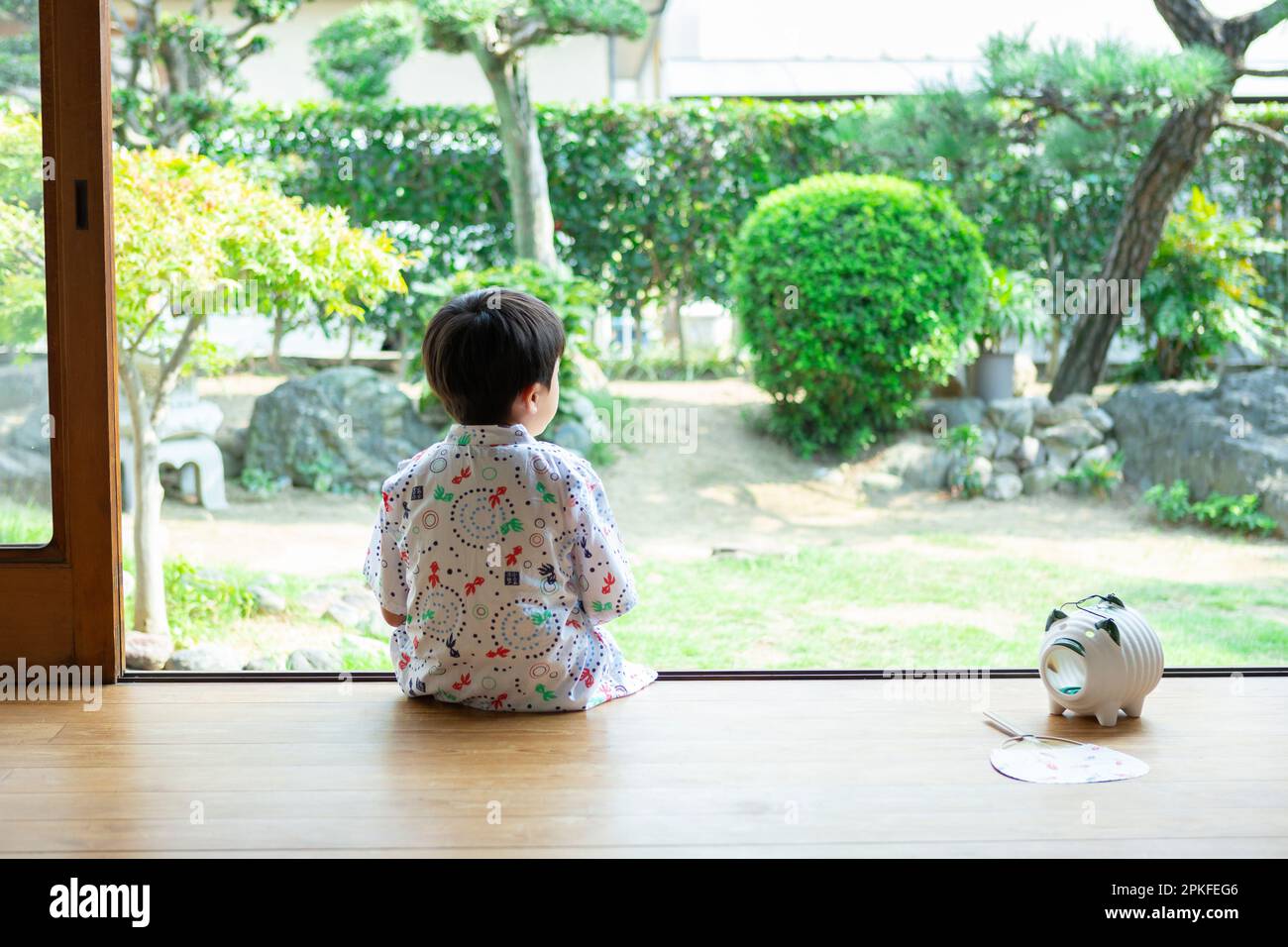 Boy sitting on the porch Stock Photo - Alamy