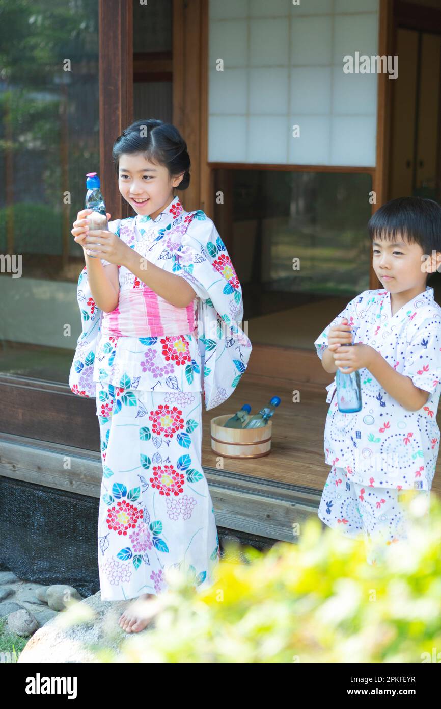 Sister and brother opening soda pop Stock Photo - Alamy