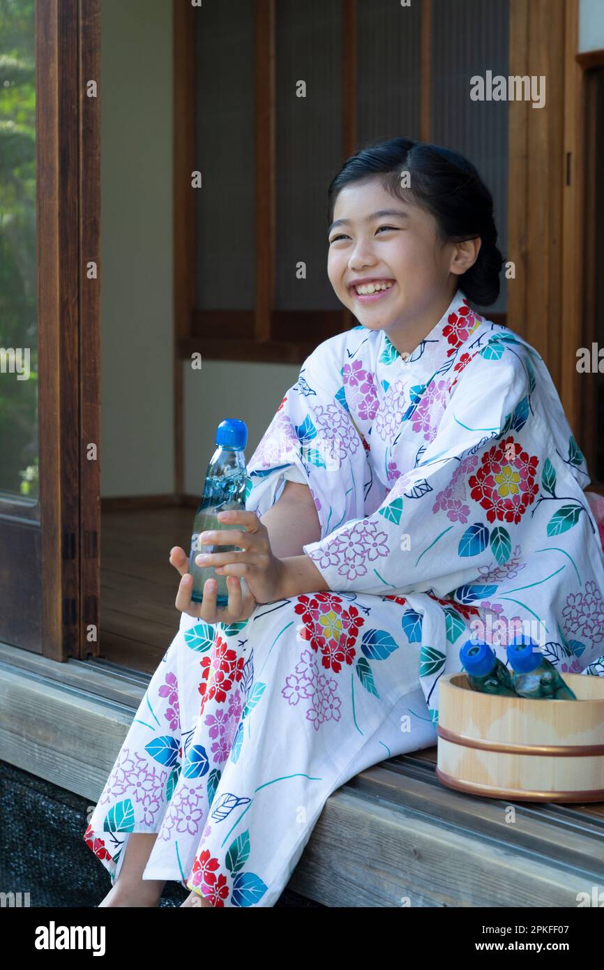 Girl drinking Ramune Stock Photo - Alamy