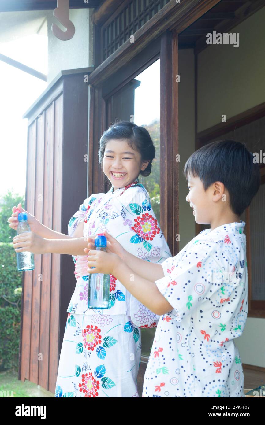 Sister and brother trying to open a bottle of soda pop Stock Photo - Alamy