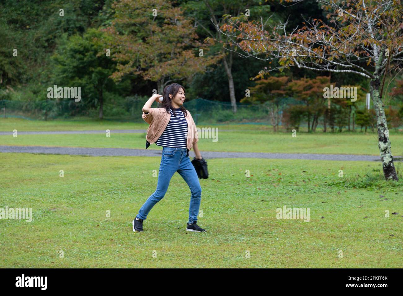 Woman throwing a ball Stock Photo - Alamy