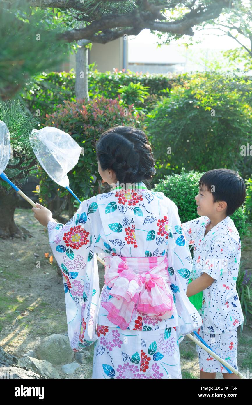 Sister and brother catching insects Stock Photo - Alamy