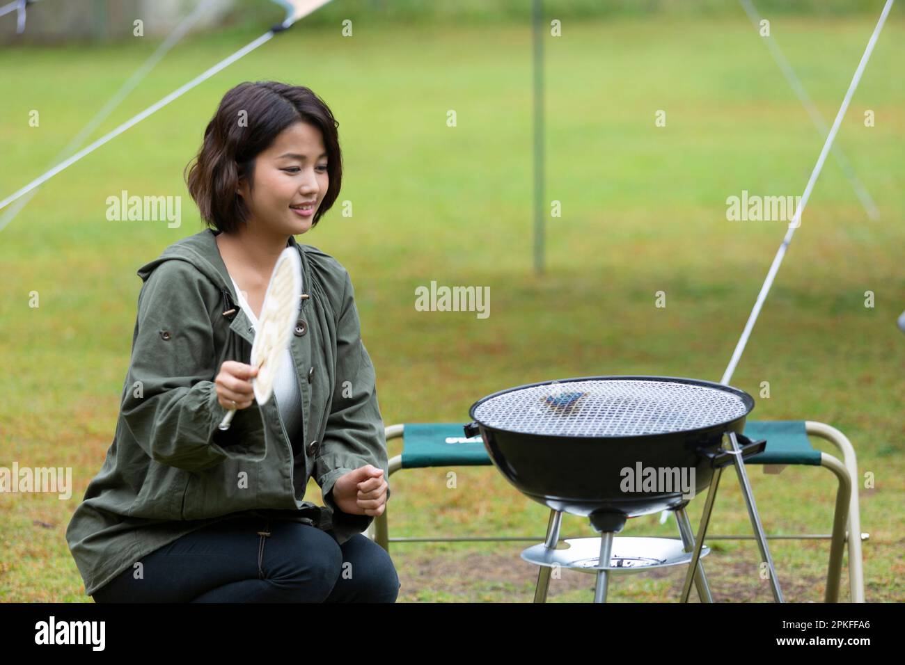 Woman making a fire Stock Photo - Alamy