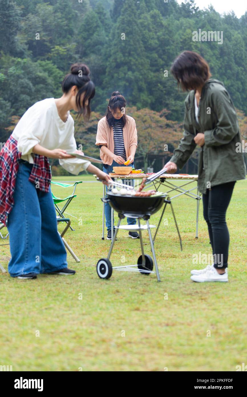 Woman at grill stove hi-res stock photography and images - Alamy