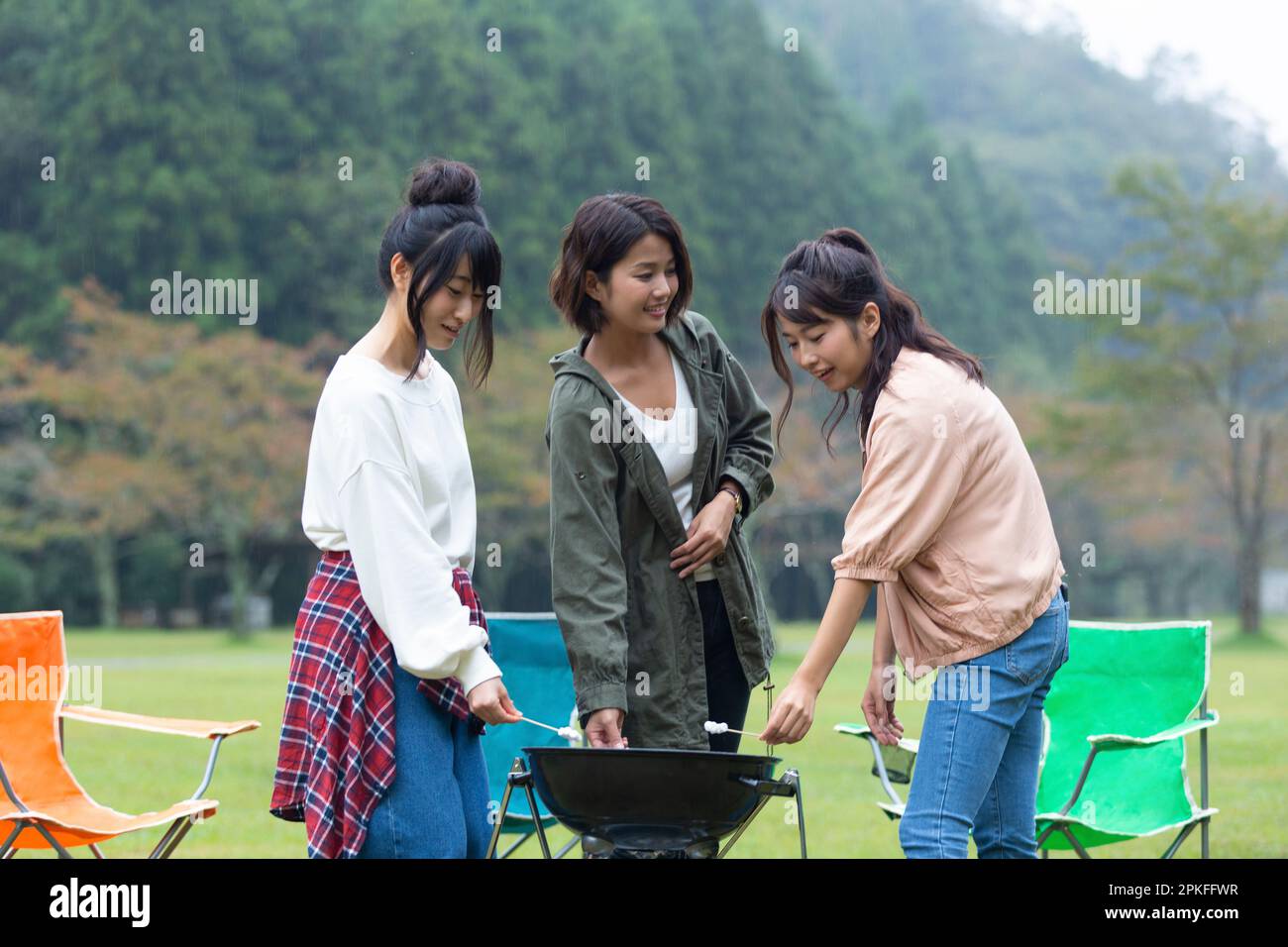 Woman roasting marshmallow Stock Photo - Alamy
