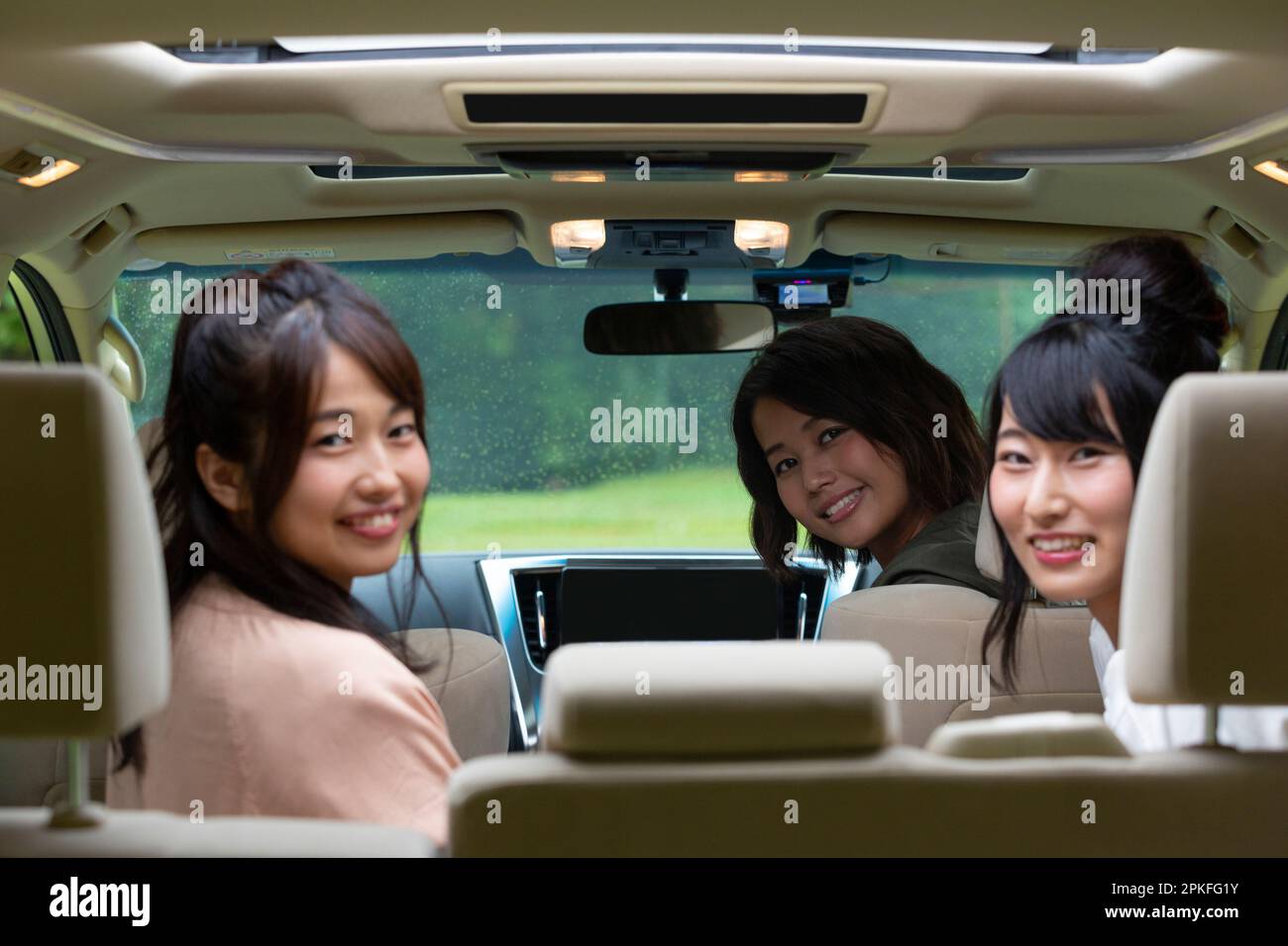 Woman looking back in car Stock Photo - Alamy