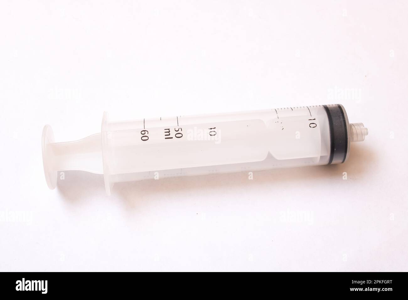 Large medical syringe on a gray background close up Stock Photo - Alamy