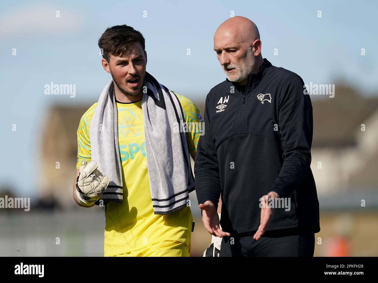 Derby County goalkeeper Joe Wildsmith speaks with goalkeeping coach ...