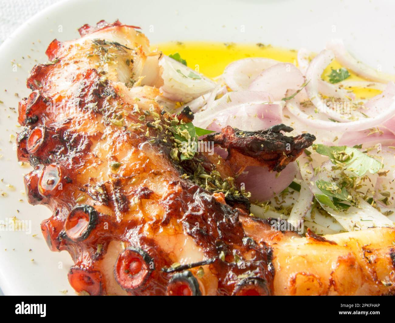 delicious fried octopus tentacle with olive oil and onion Stock Photo ...