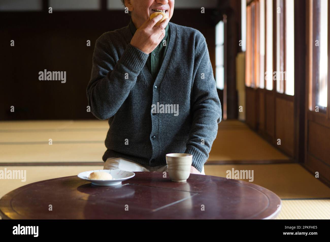 Senior man drinking tea at a country house Stock Photo - Alamy