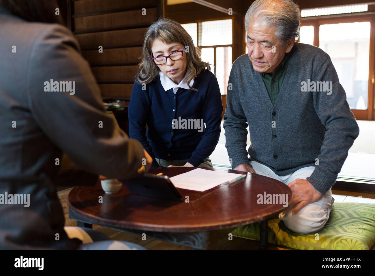 Senior couple listening to visitor's description at country house Stock ...