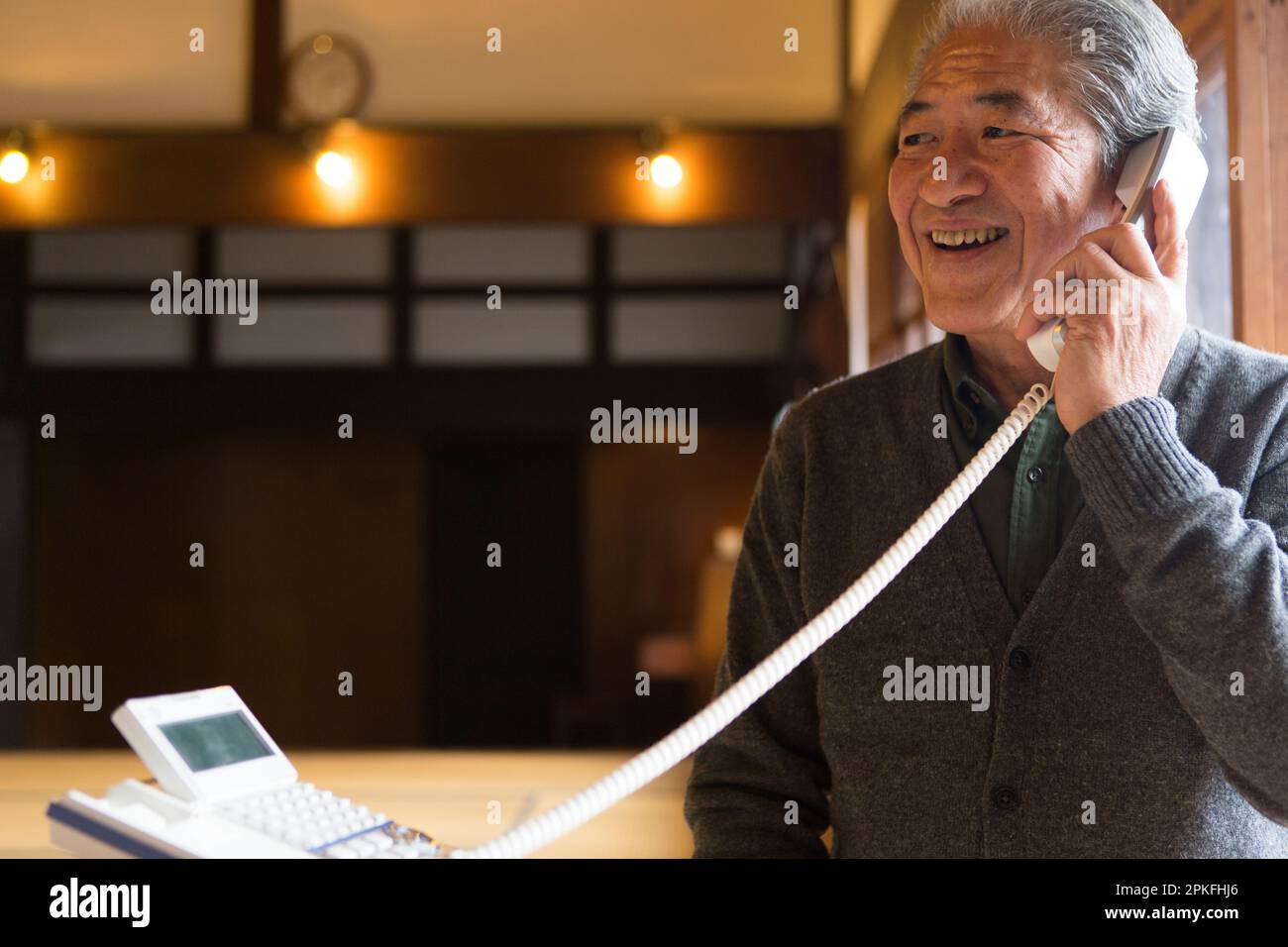 Senior man making a phone call in a country house Stock Photo - Alamy