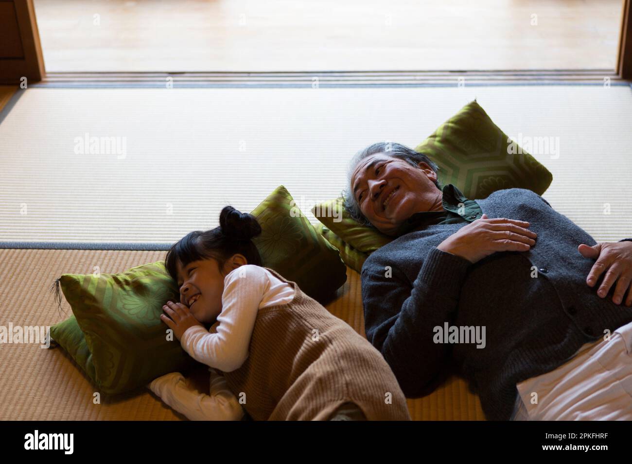 Child relaxing with grandfather hi-res stock photography and images - Alamy