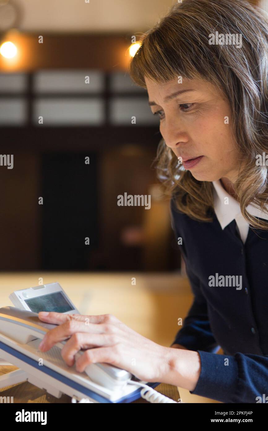 Senior woman making phone call at country house Stock Photo - Alamy