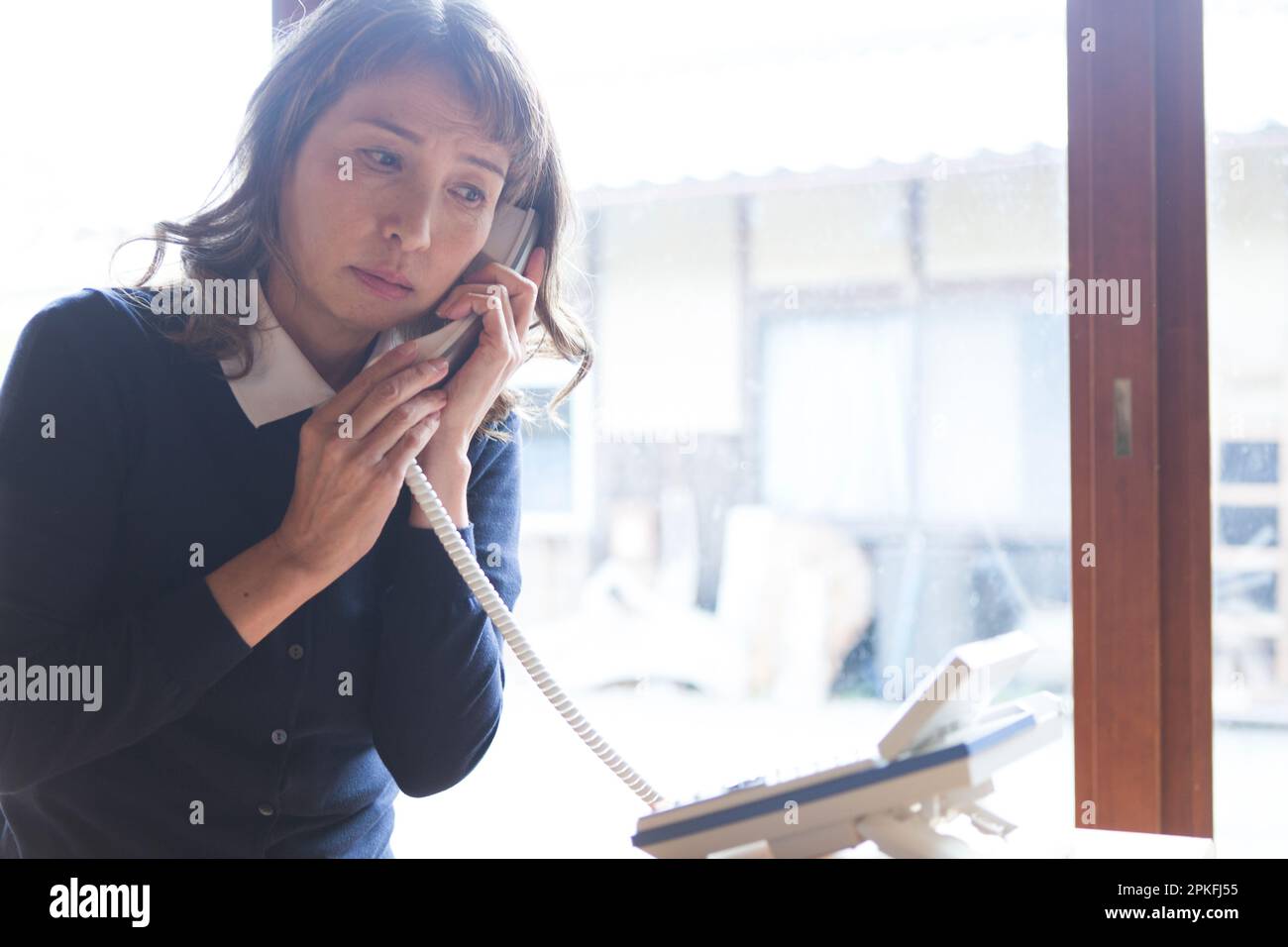 A senior woman making a phone call in a country house Stock Photo - Alamy