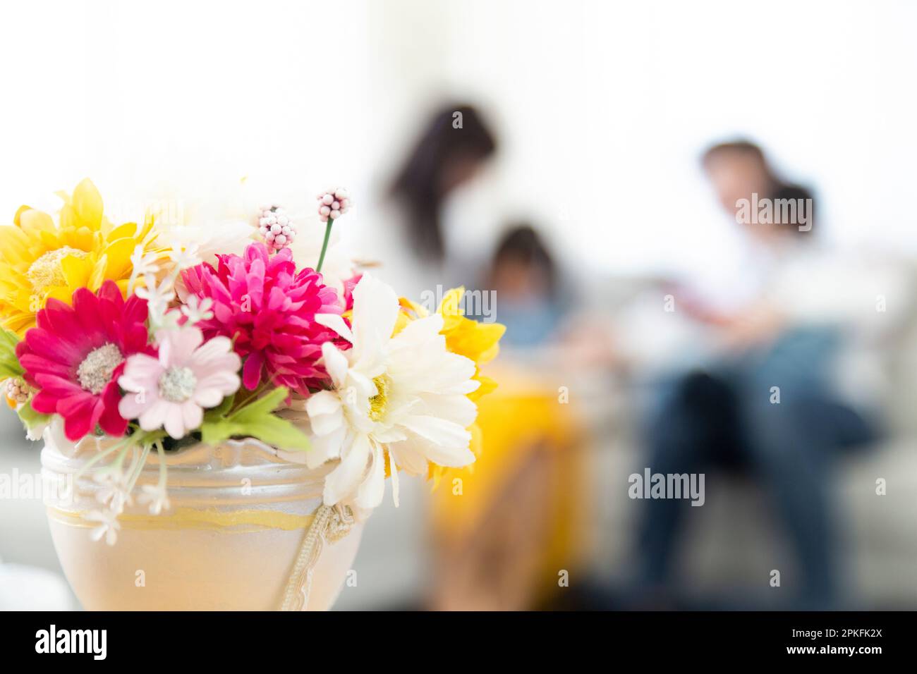 Family over flower arrangement Stock Photo - Alamy