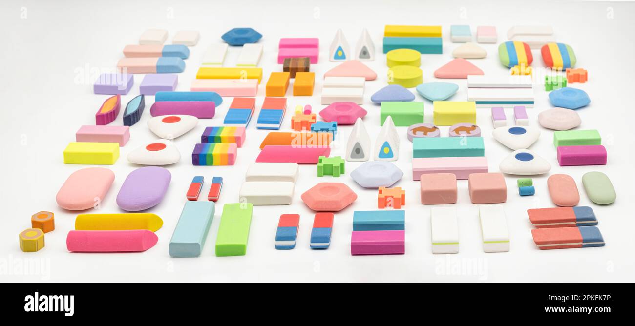 various shapes and colors of erasers arranged isolated on white ...