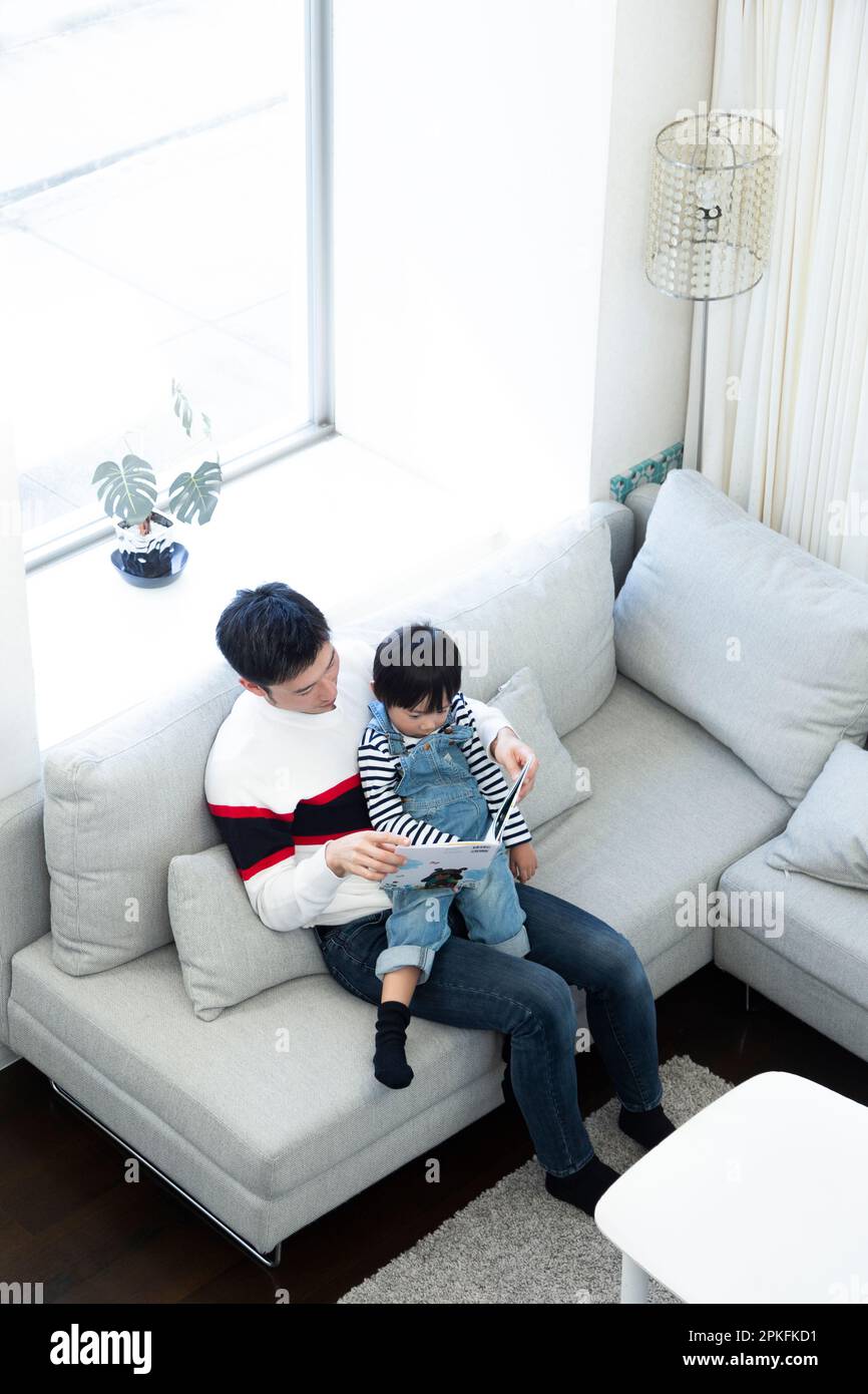 Parent and child playing on the couch Stock Photo - Alamy