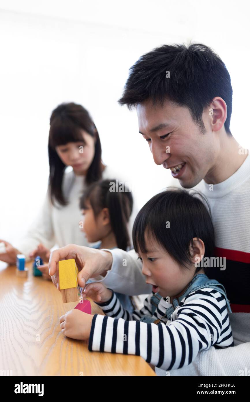 Young family building blocks hi-res stock photography and images - Alamy