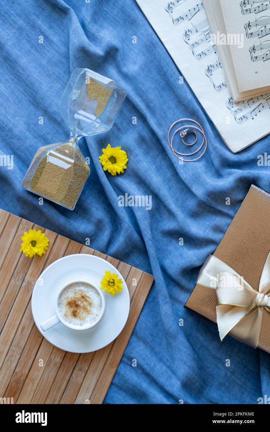 A cup of coffee, an hourglass of music notes and a box of chocolates ...