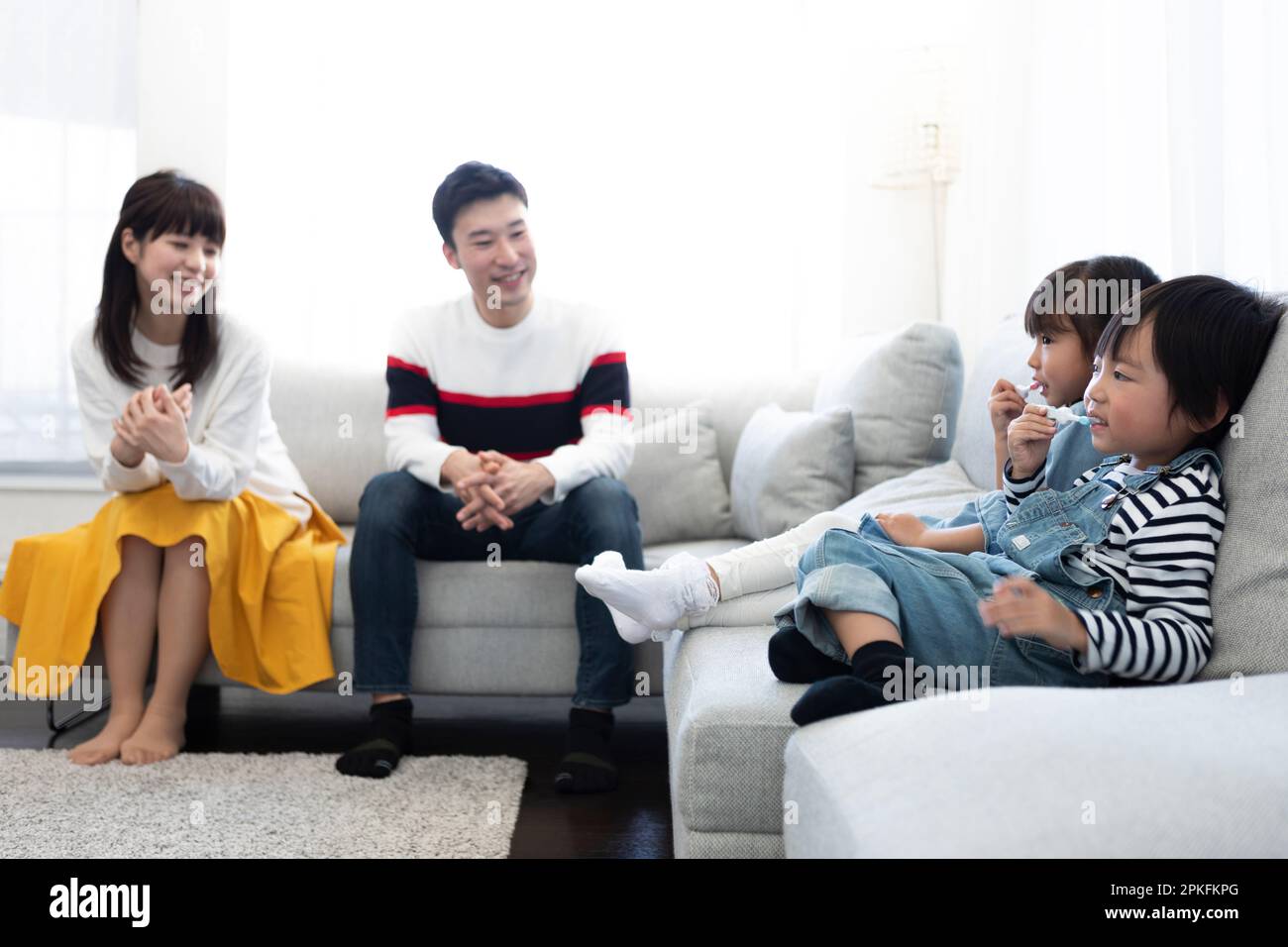 Parents watching their children brushing their teeth Stock Photo - Alamy
