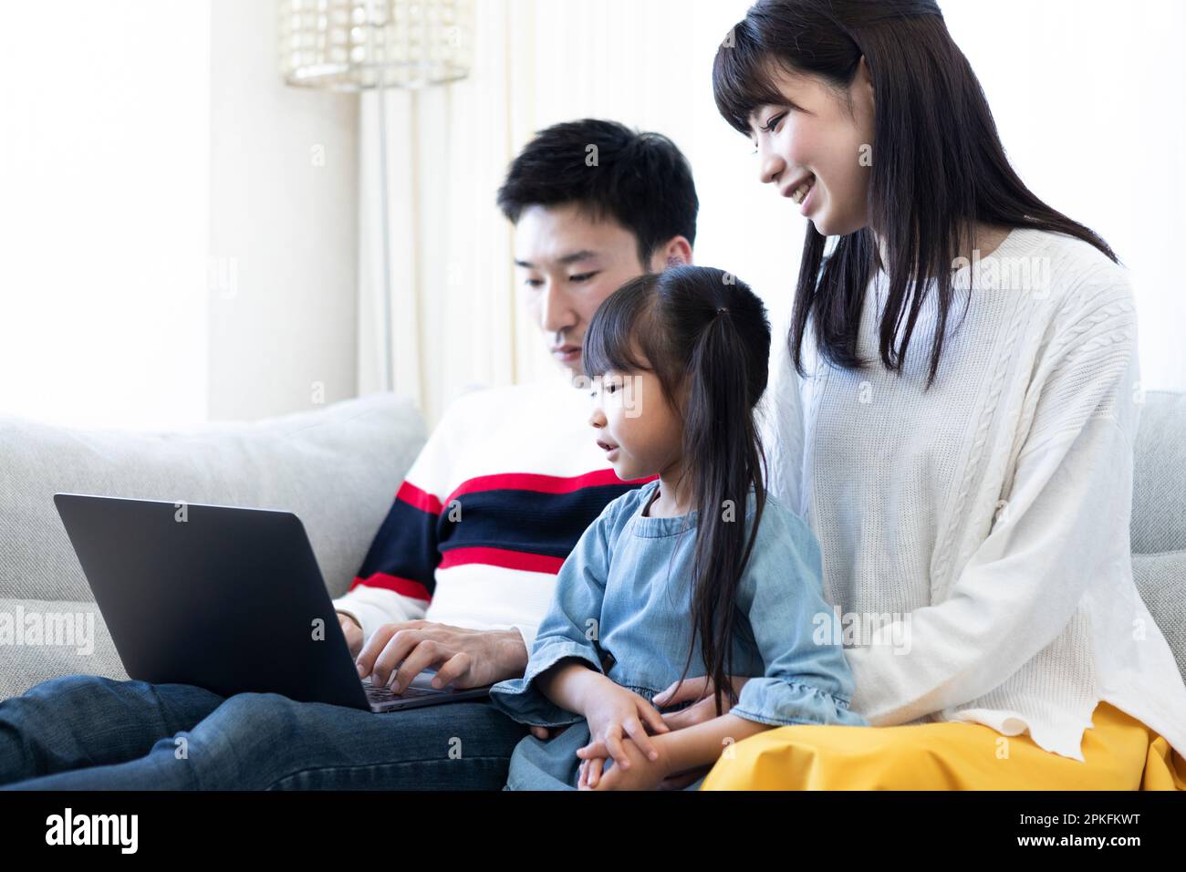 Family watching computer Stock Photo - Alamy
