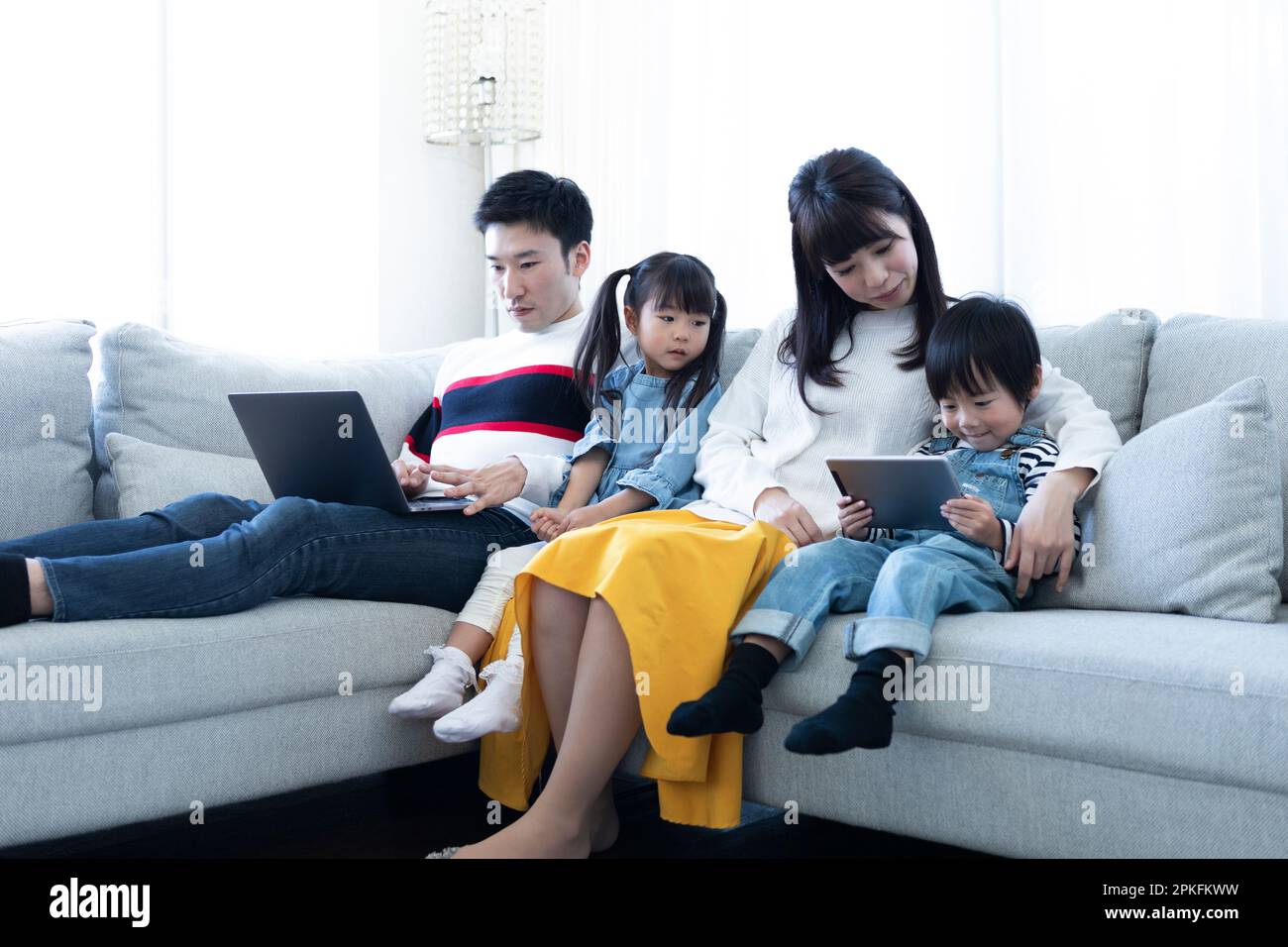 Family watching computer and tablet Stock Photo - Alamy