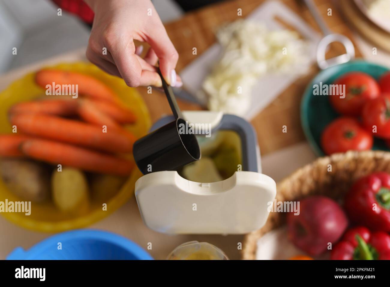 Female person pouring bokashi ferment in a compost bin. Woman cooking ...