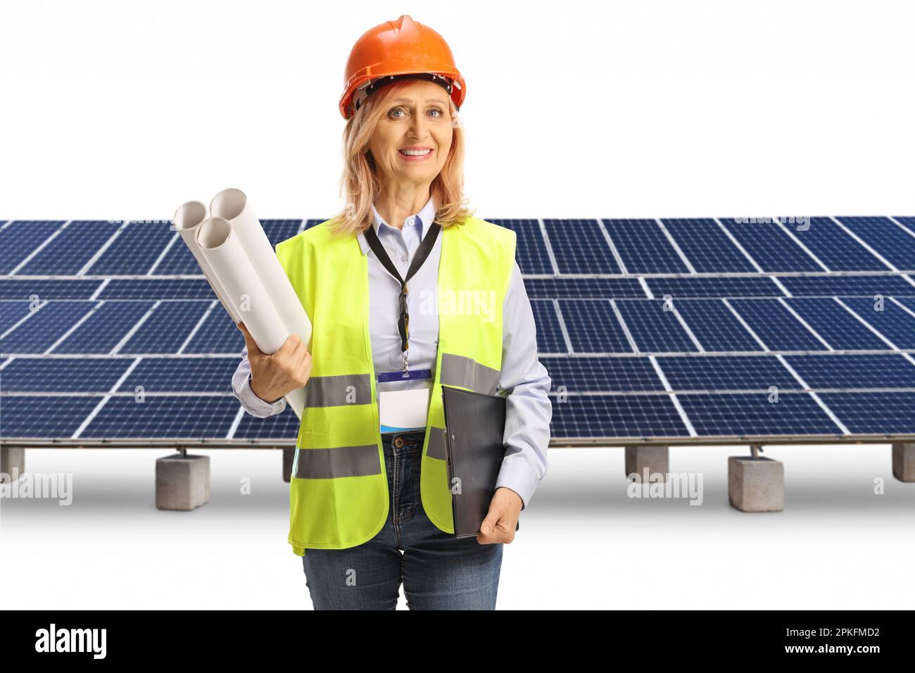 Female engineer holding print plans in front of photovoltaic panels ...