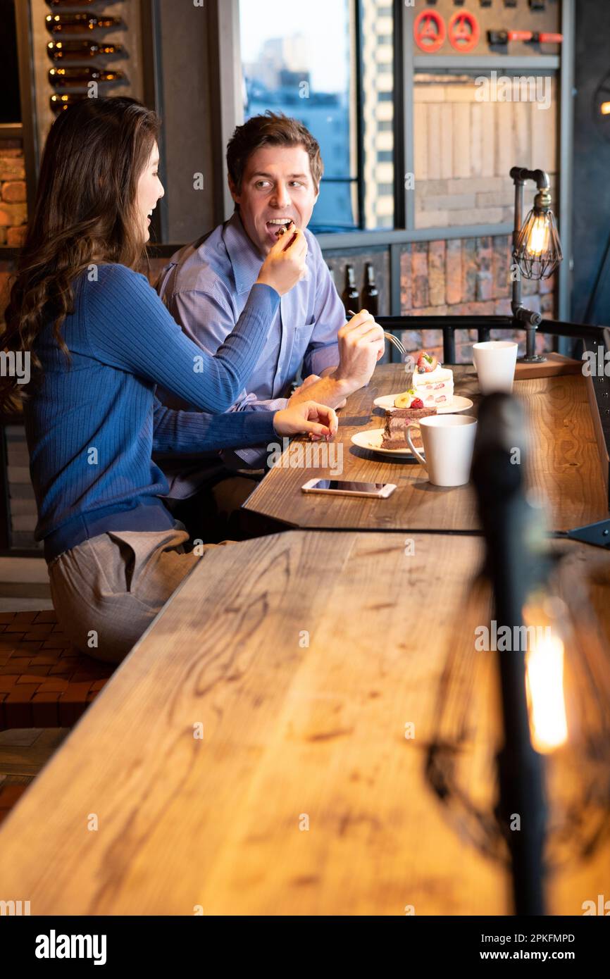 Couple feeding each other Stock Photo - Alamy