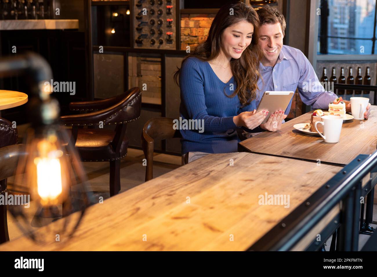 Couple looking at tablets Stock Photo - Alamy