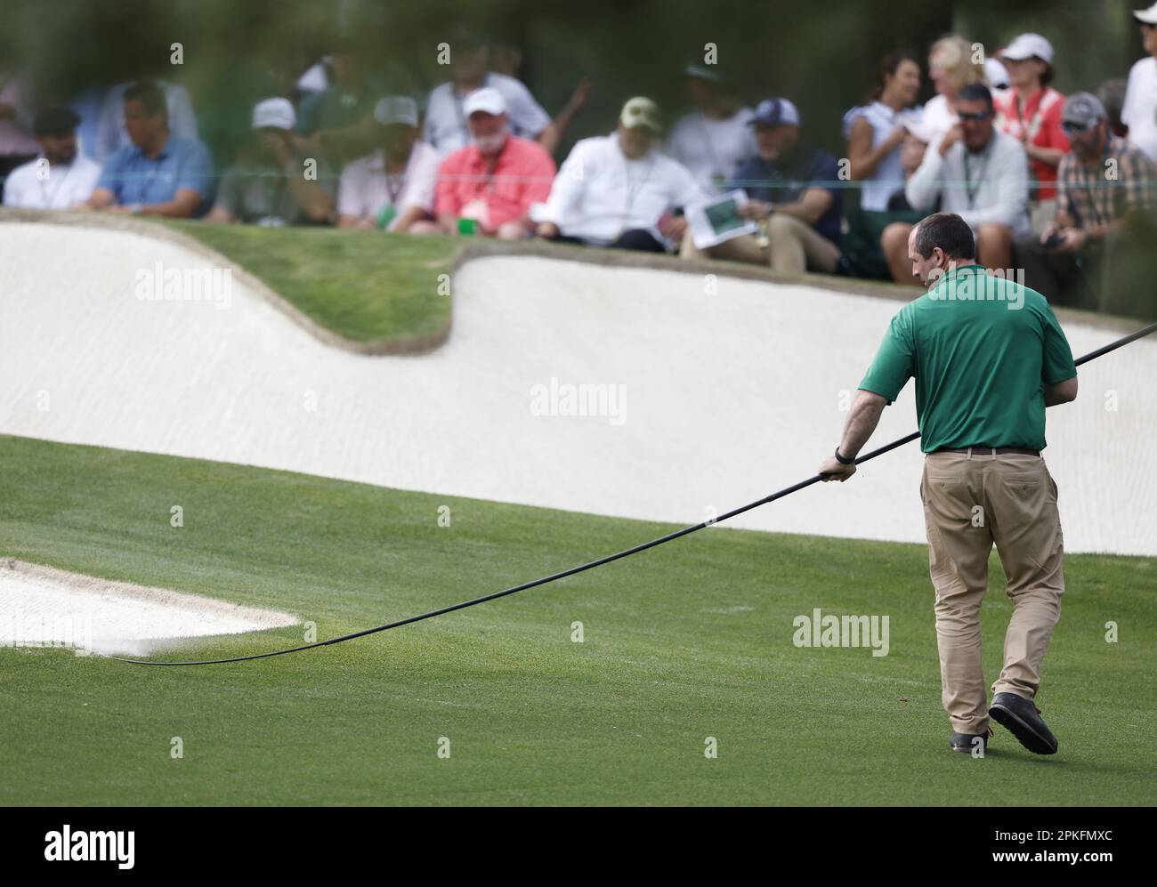 Augusta, United States. 07th Apr, 2023. A worker removes sand from the ...
