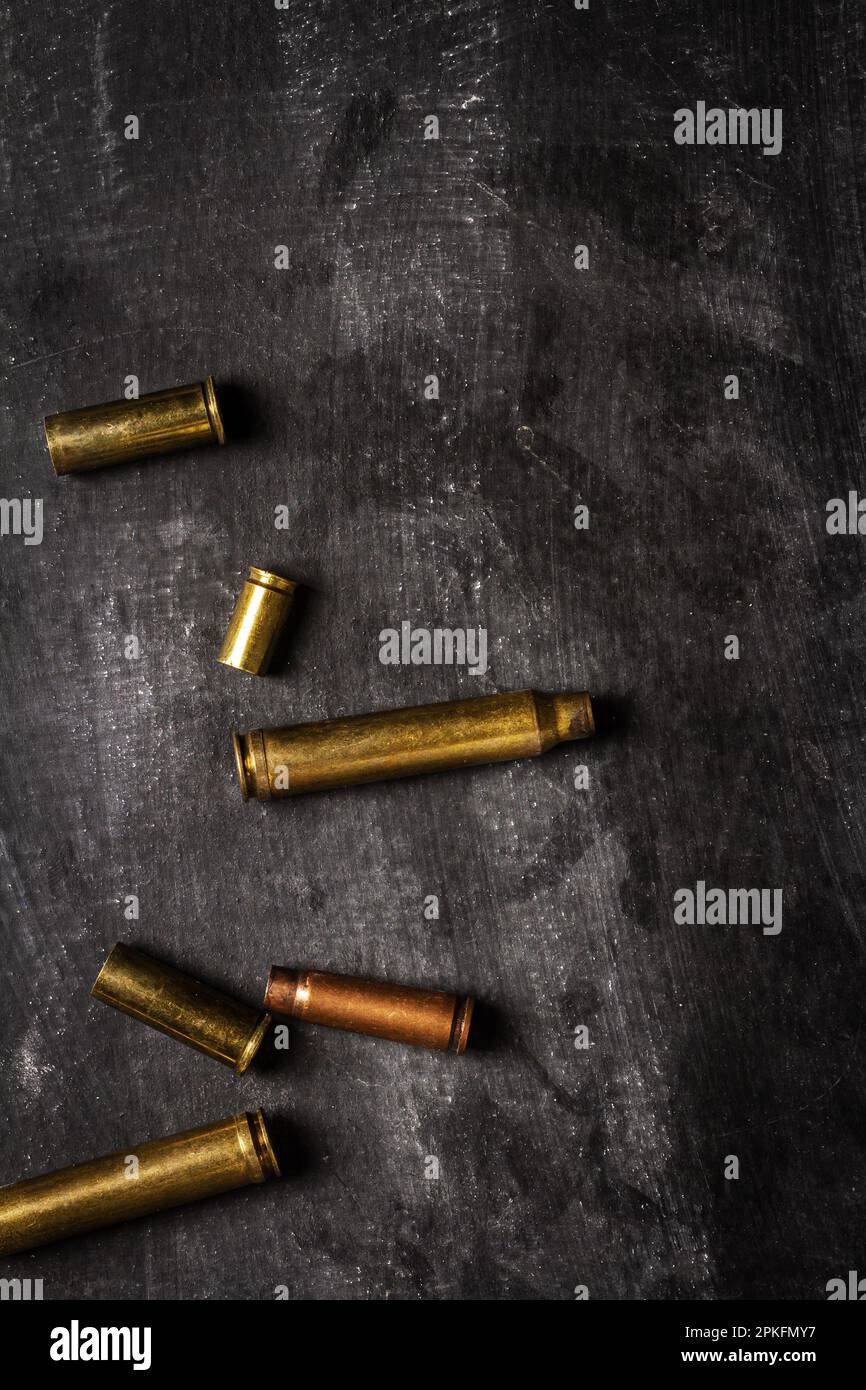 Empty bullet cartridges lying on the black background Stock Photo - Alamy