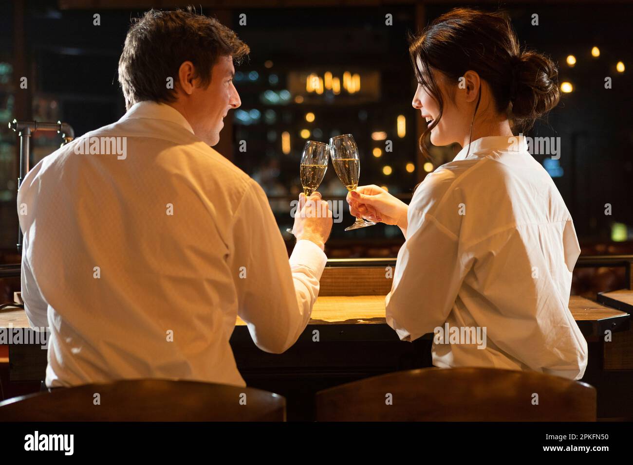 Couple making a toast Stock Photo - Alamy