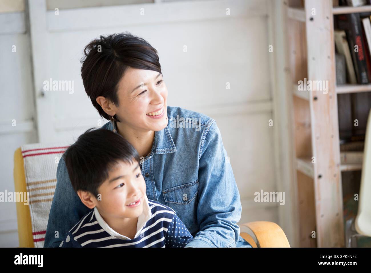 A boy sits on his mother's lap Stock Photo - Alamy