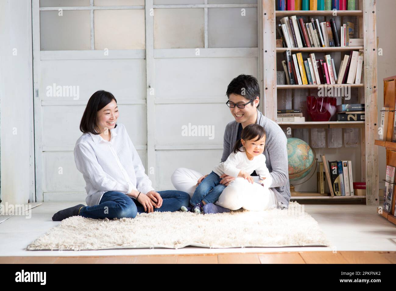 Family hanging out in the living room Stock Photo - Alamy