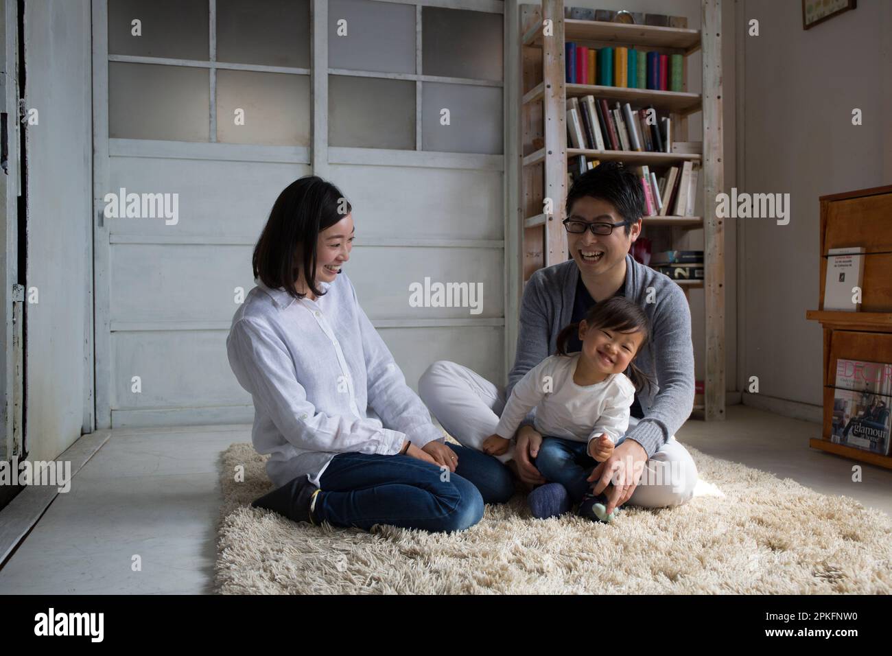 Family hanging out in the living room Stock Photo - Alamy