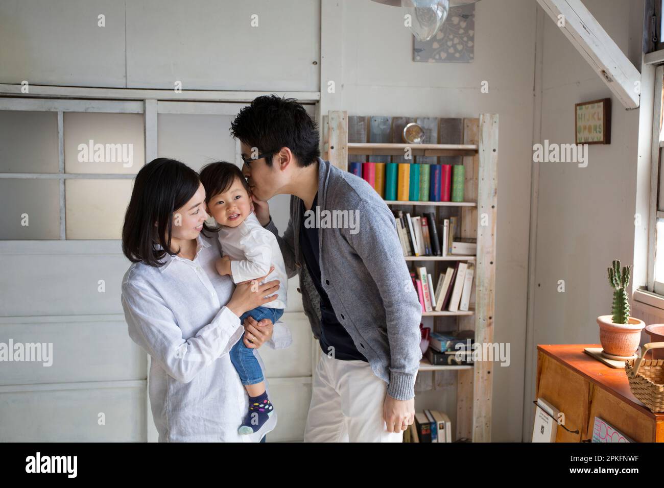 Family hanging out in the living room Stock Photo - Alamy