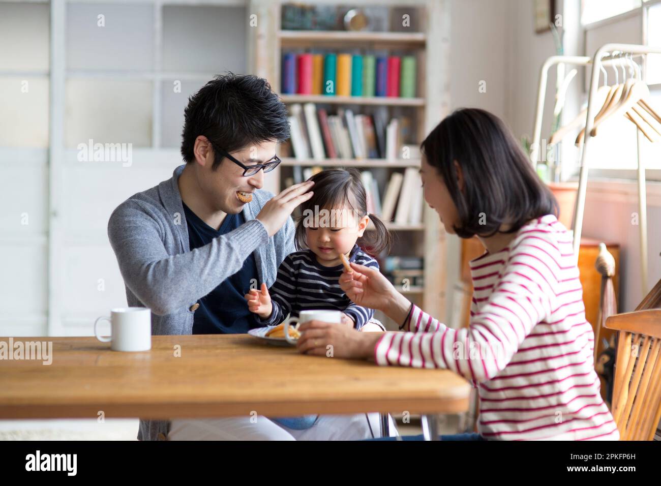 Family relaxing in the living room Stock Photo - Alamy