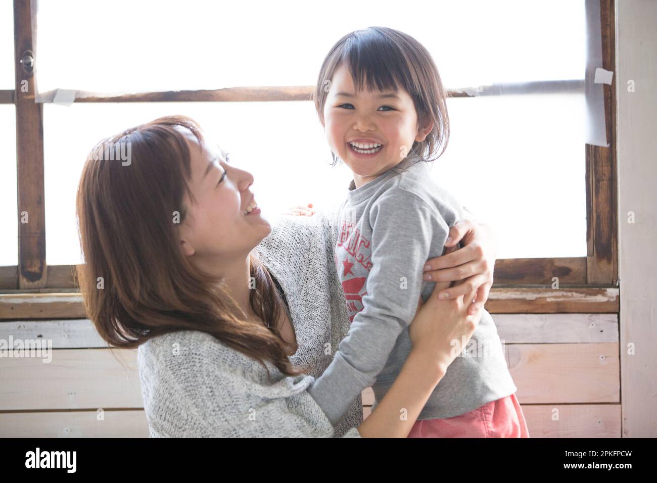 Mother looking at her daughter with a smile Stock Photo - Alamy