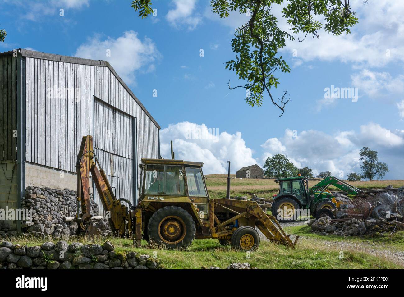 An old digger pictured in a farmyard in Yorkshire, England Stock Photo ...