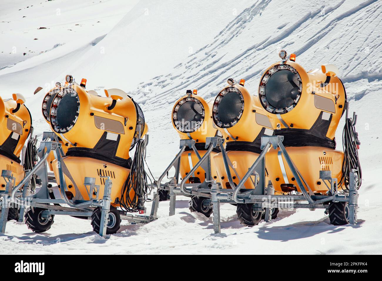 Group of yellow snow cannons are waiting for the start of the ski ...