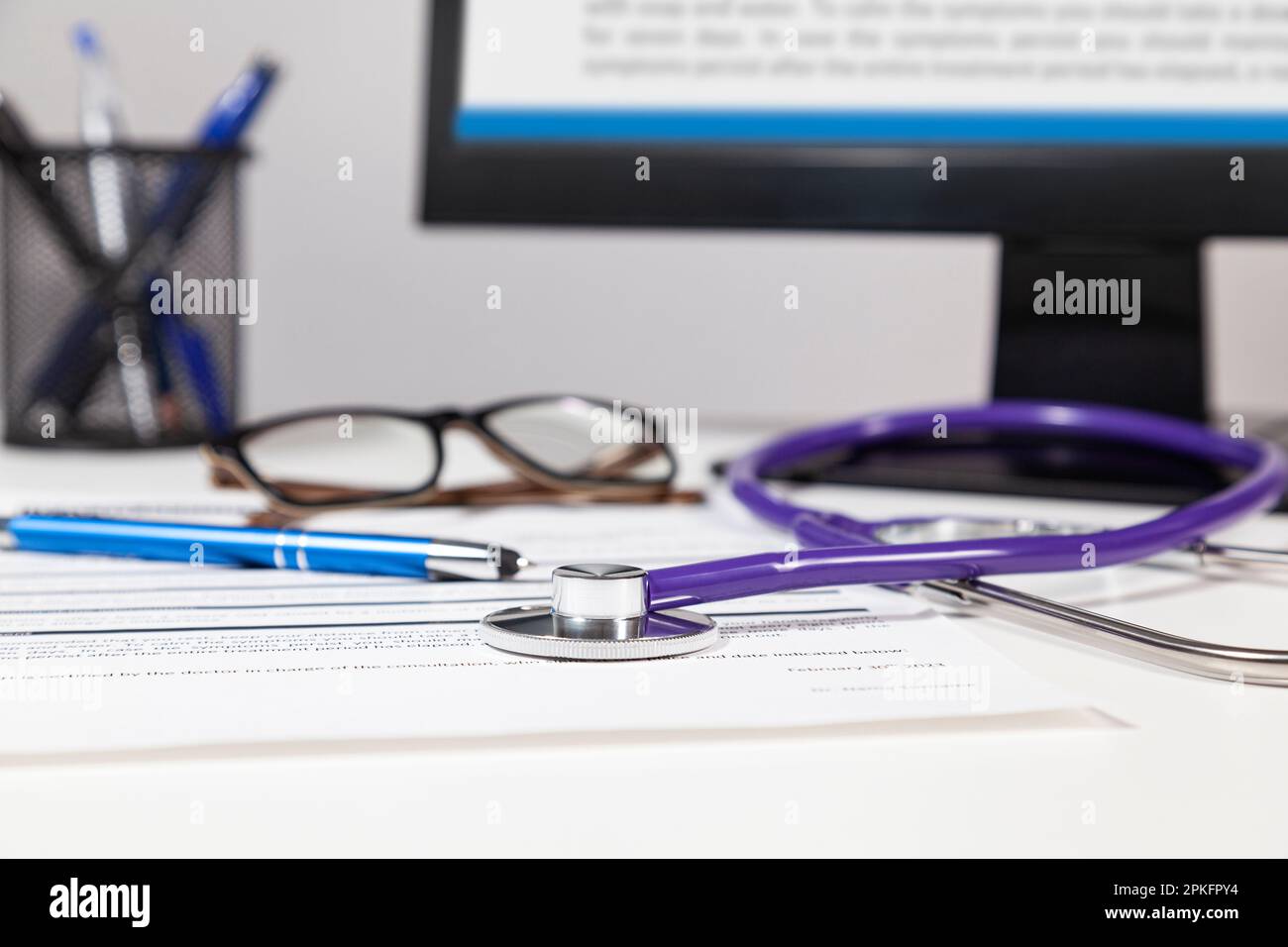 Close-up of a stethoscope over a doctor's white table where are a ...